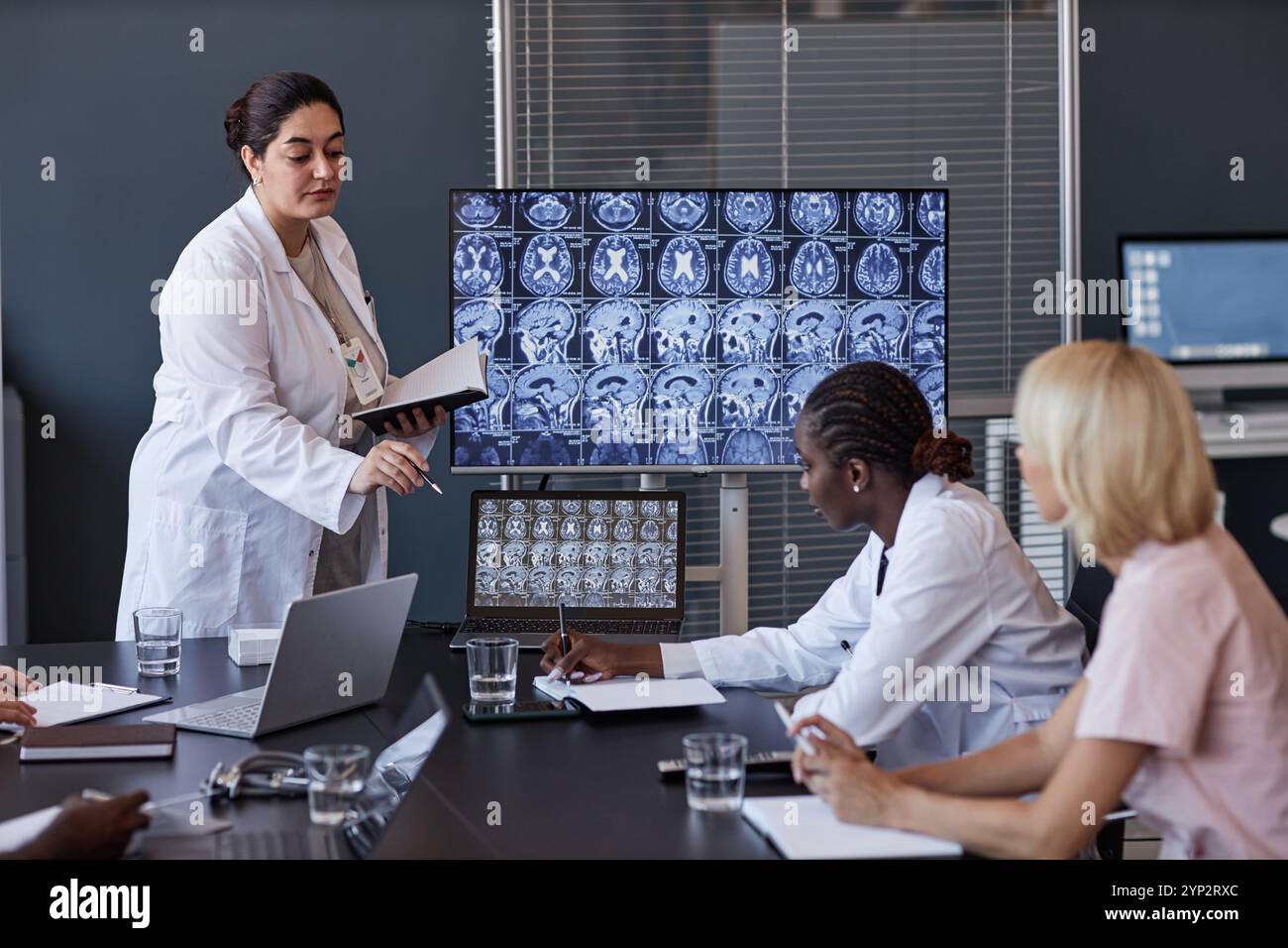Professional female radiologist of Middle Eastern ethnicity showing MRI ...