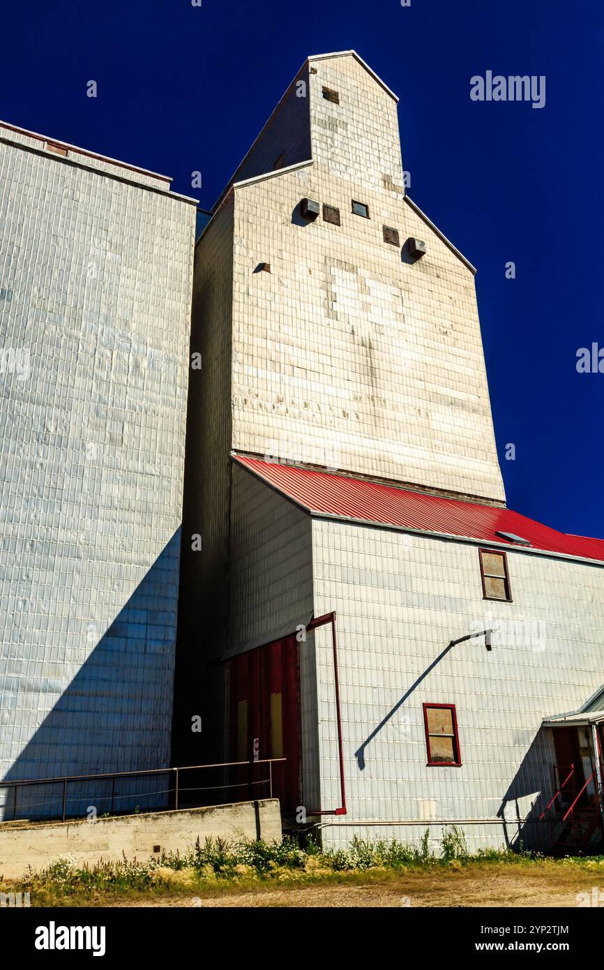 A large white building with a red roof. The building is empty and has a ...