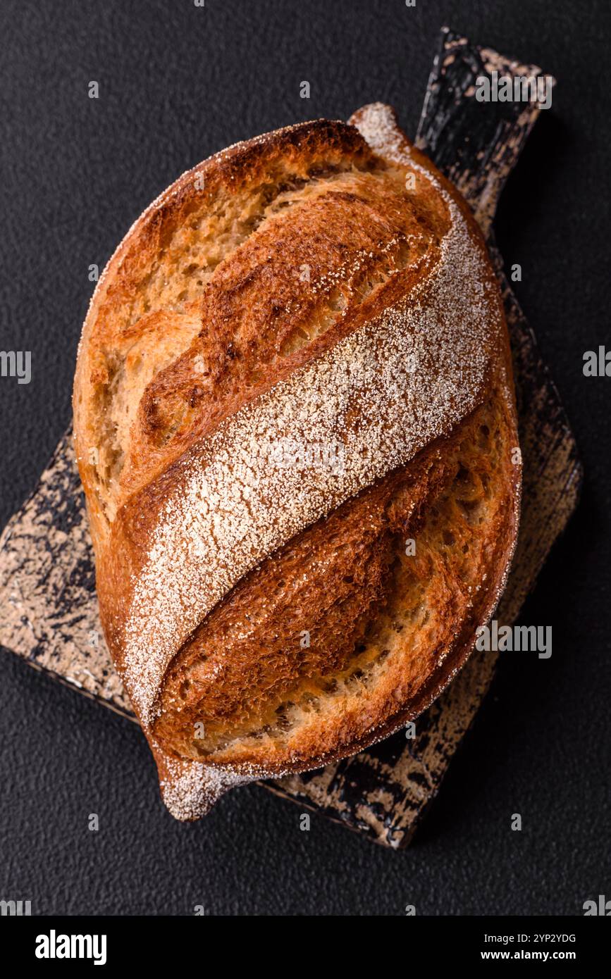 Homemade fresh crispy wholemeal bread on dark concrete background Stock ...