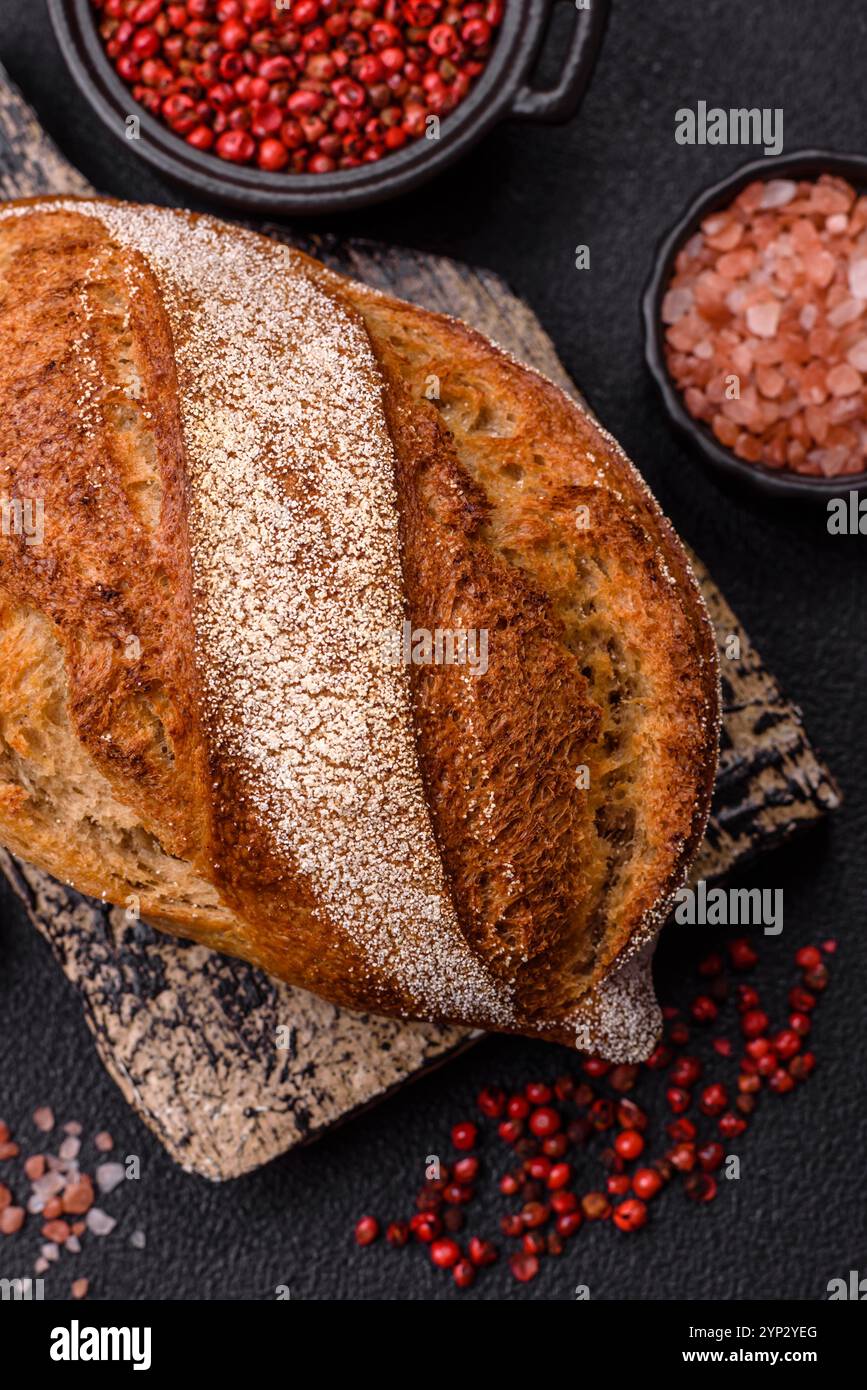 Homemade fresh crispy wholemeal bread on dark concrete background Stock ...