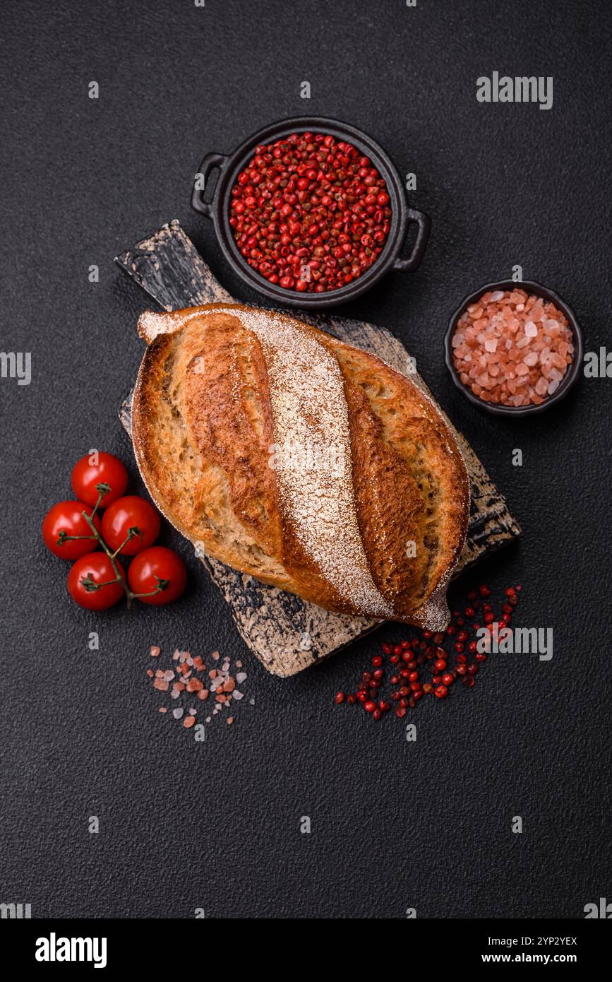 Homemade fresh crispy wholemeal bread on dark concrete background Stock ...
