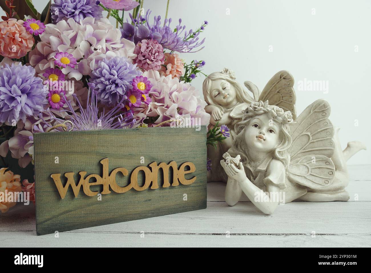 Welcome sign with flowers bouquet and angel statues home decorations ...