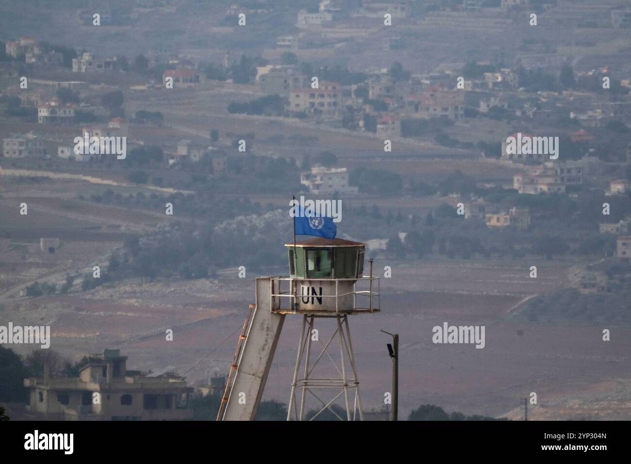 An United Nations flag waves on the top of a tower in a base of the ...
