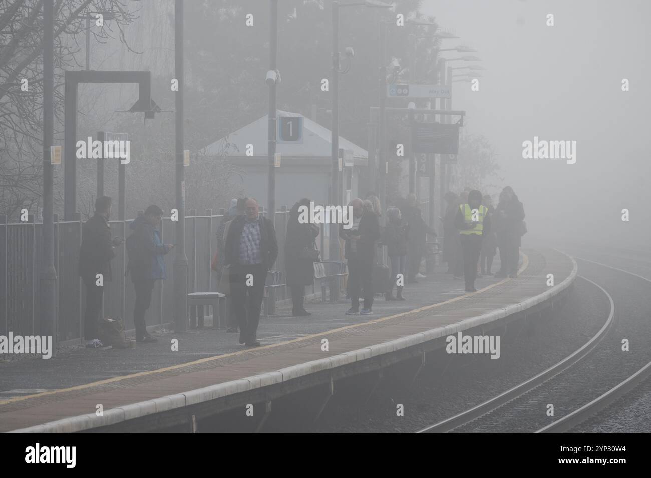 Passengers waiting in foggy, frosty weather at Warwick Parkway railway ...