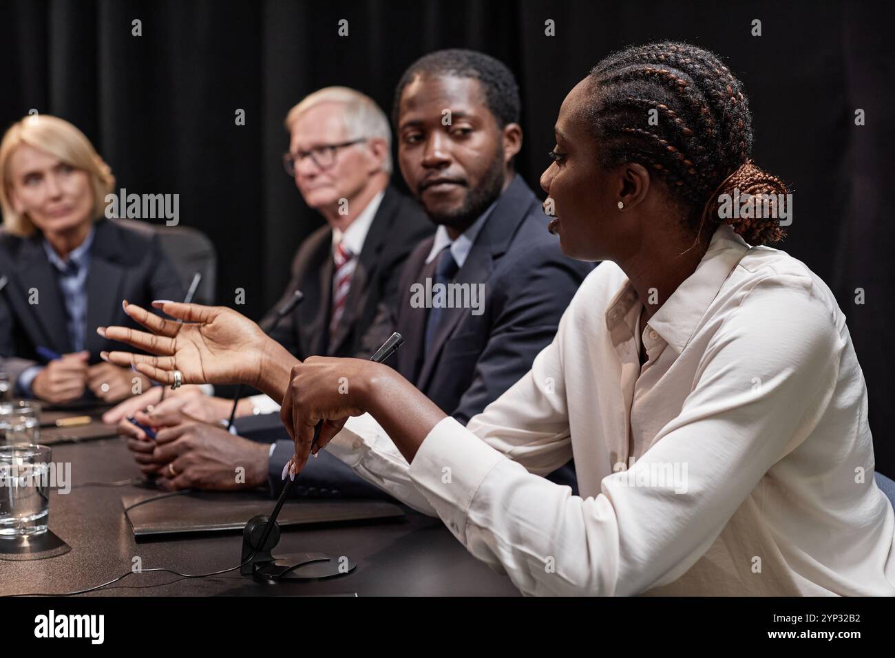 Side view of African American female politician asking colleague ...