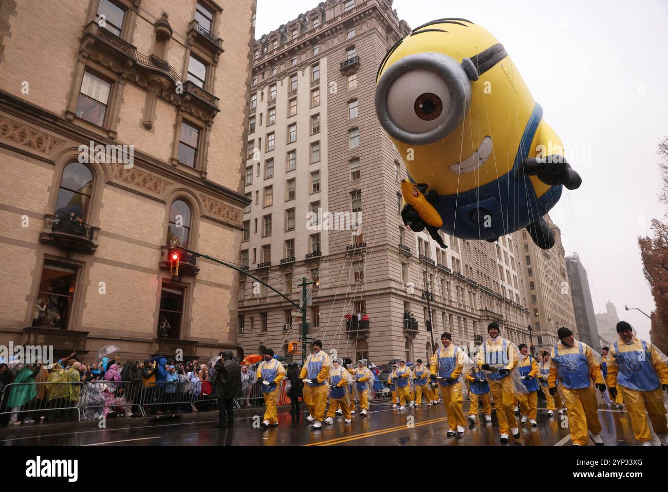 Handlers pull the Stuart the Minion balloon down Central Park West ...