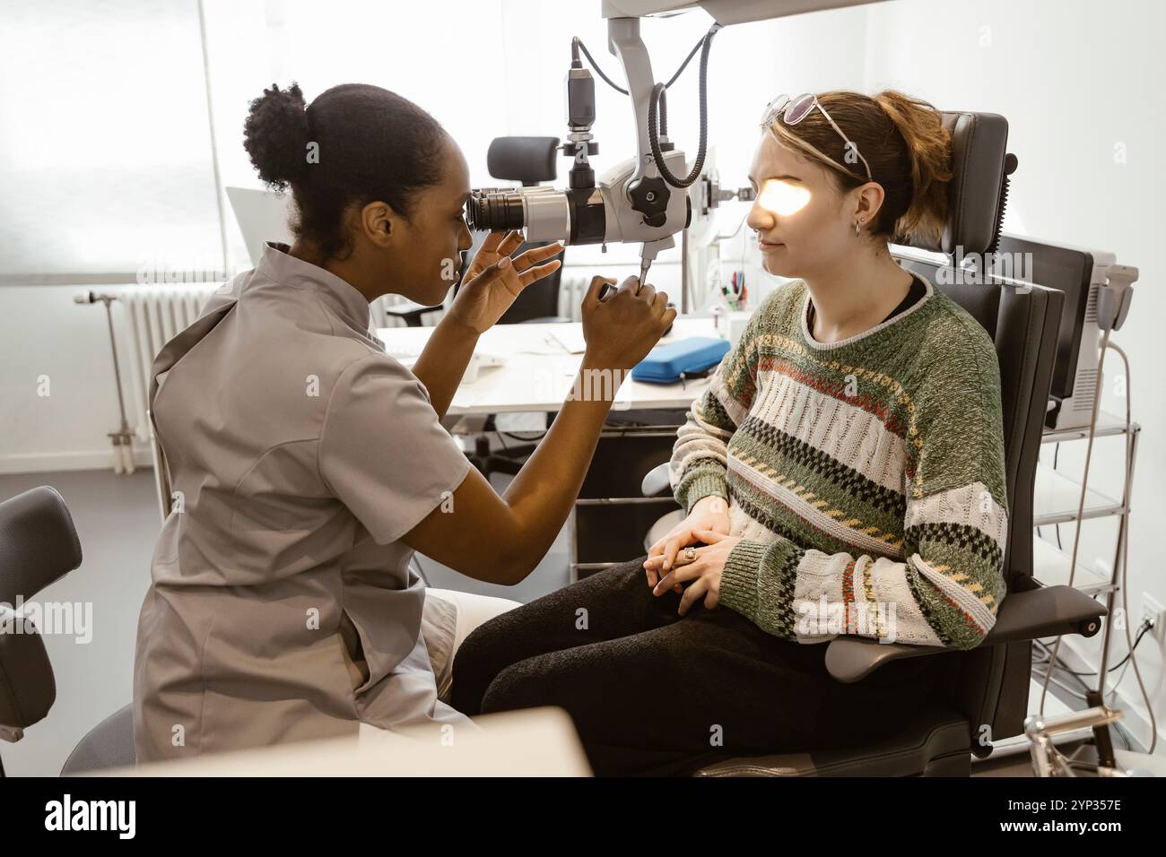 Doctor examining eye in hi-res stock photography and images - Alamy