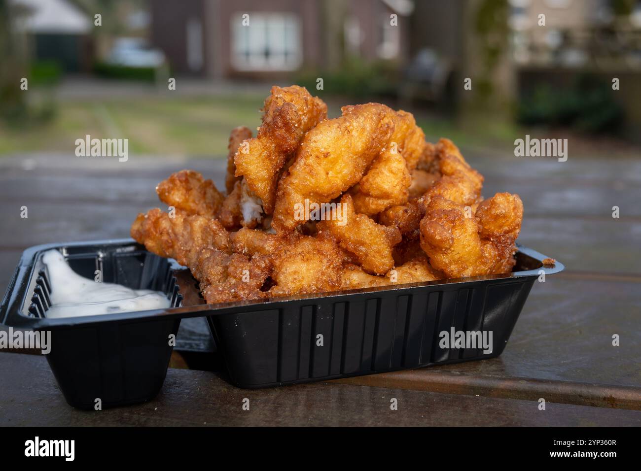 Seafood, outdoor eating of diep-fried cod fish pieces served with ...