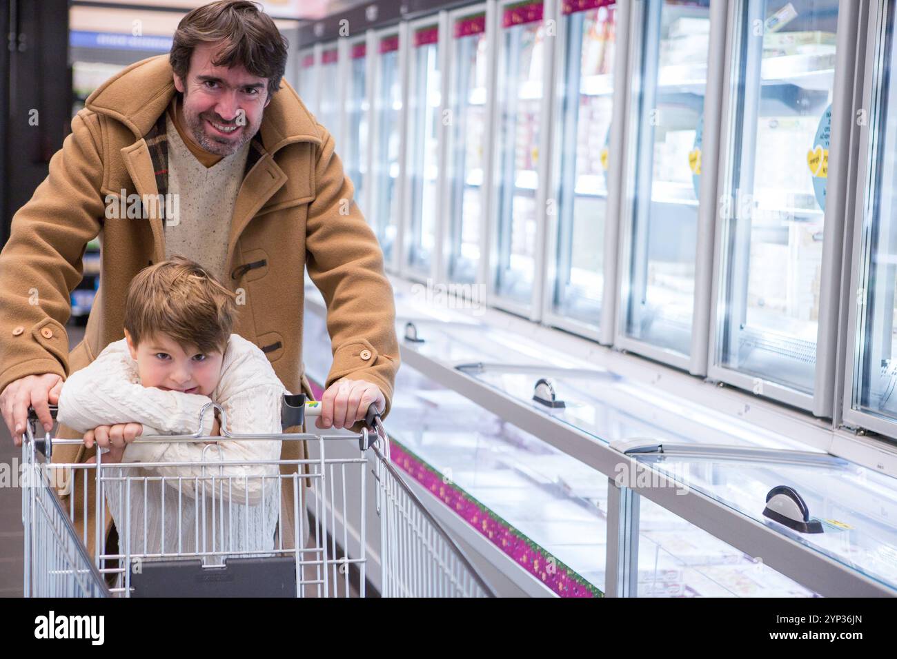 24 November 2024: Father and son shopping together in the supermarket ...