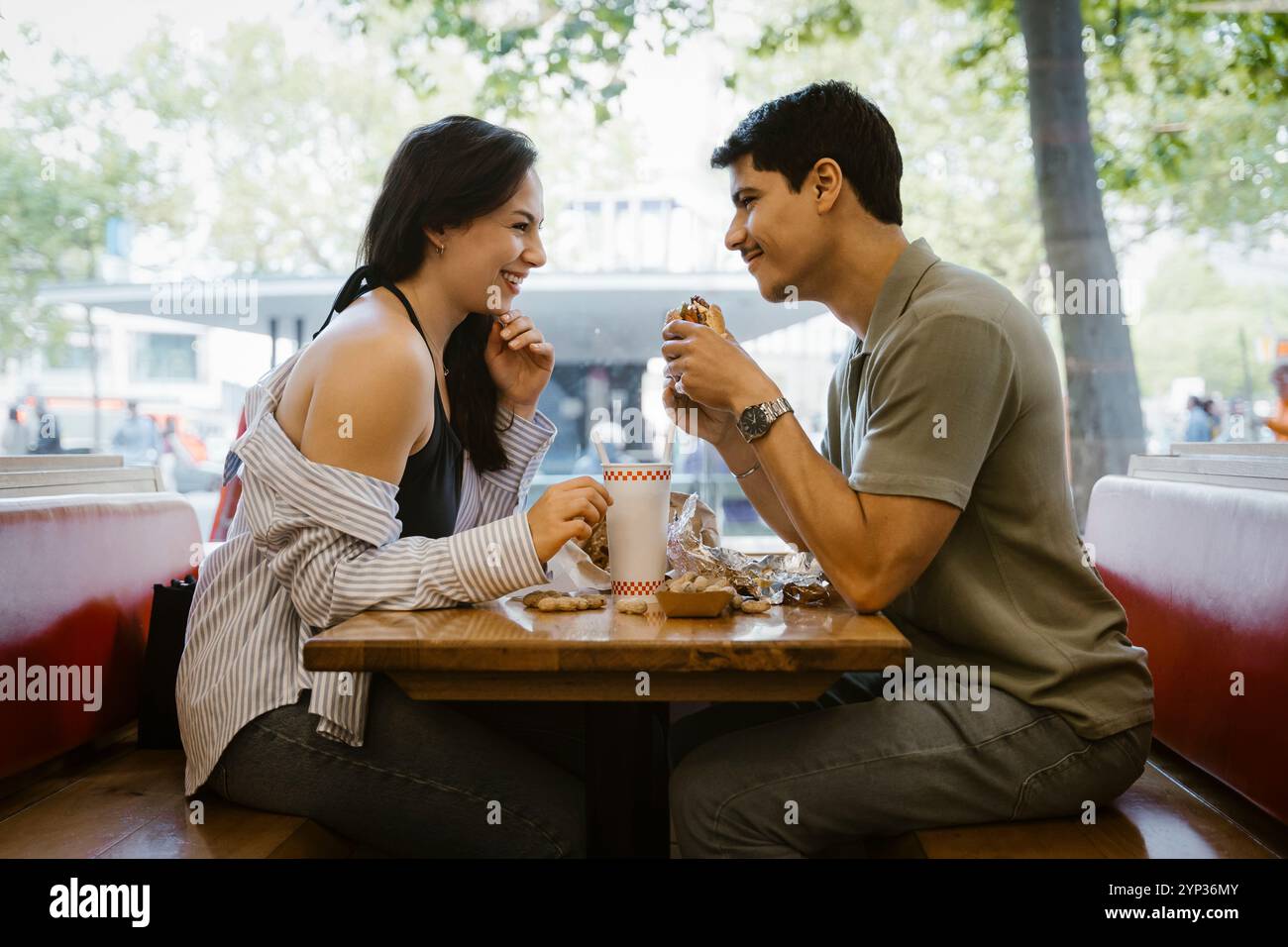 Smiling face to face communication food and drink sitting hi-res stock ...