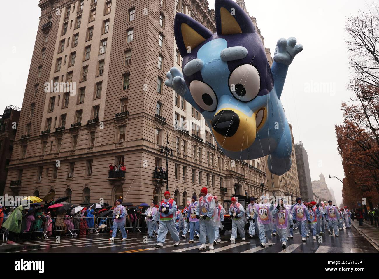 Handlers pull the Bluey balloon down Central Park West during the Macy ...