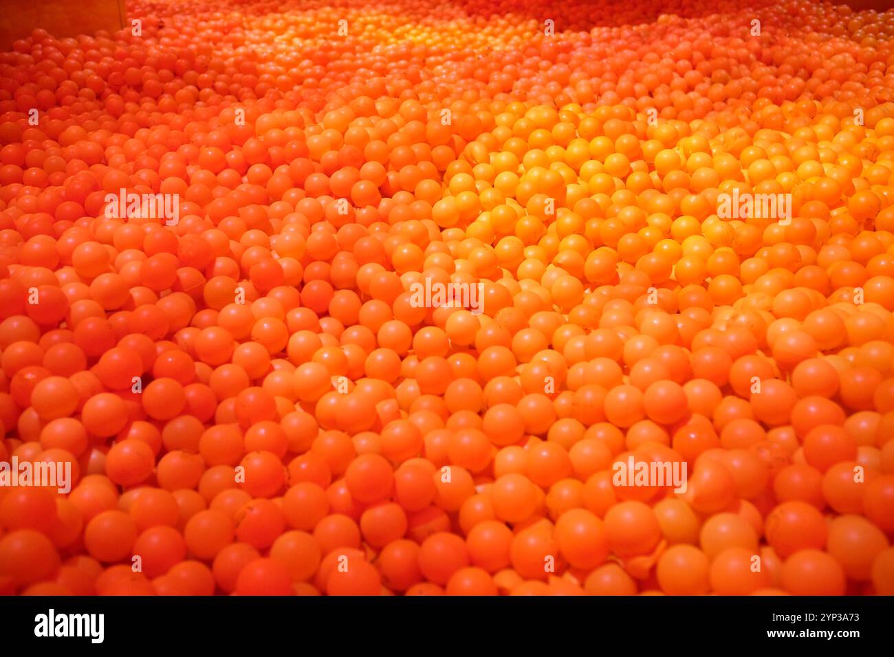 Huge ball pit with orange plastic balls Stock Photo - Alamy