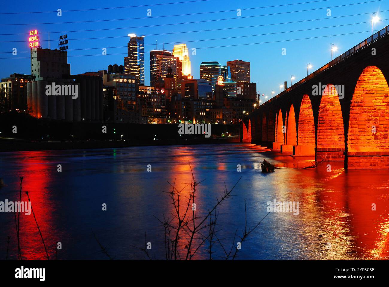 The skyline of Minneapolis, Minnesota and the Stone Arch Bridge are ...