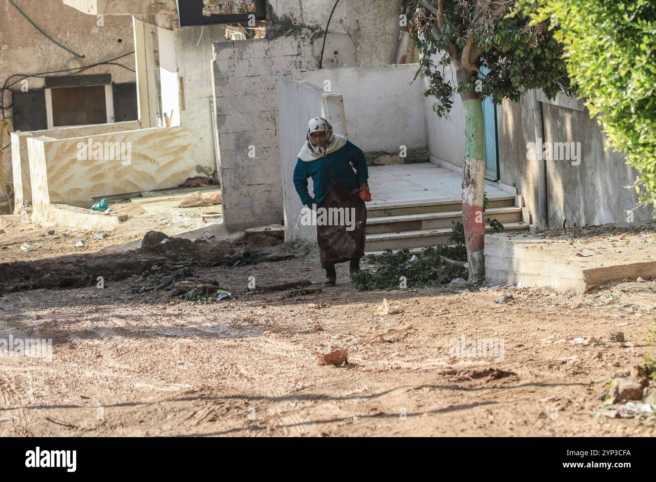 Tubas, Palestine. 28th Nov, 2024. A Palestinian woman walks along a ...
