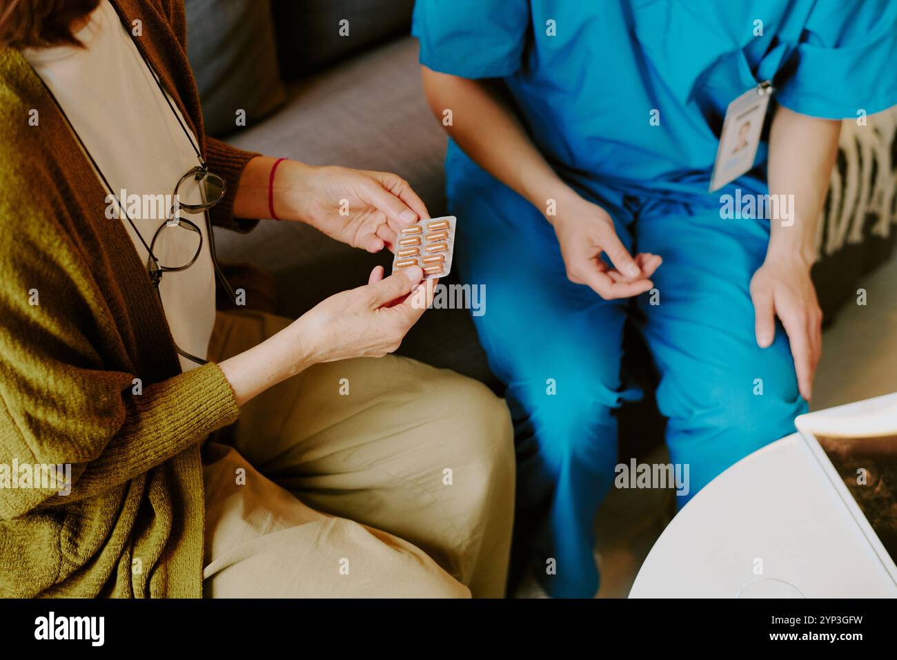 Assisting elderly patient with medication guidance, healthcare ...