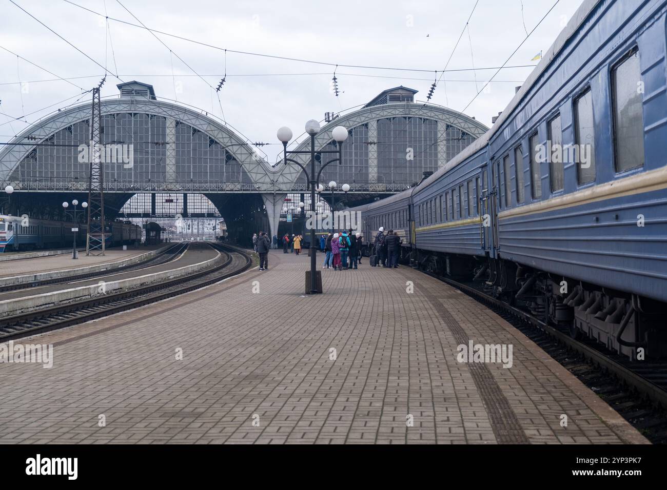 Train Station with Arched Roofs and Blue Train Stock Photo - Alamy