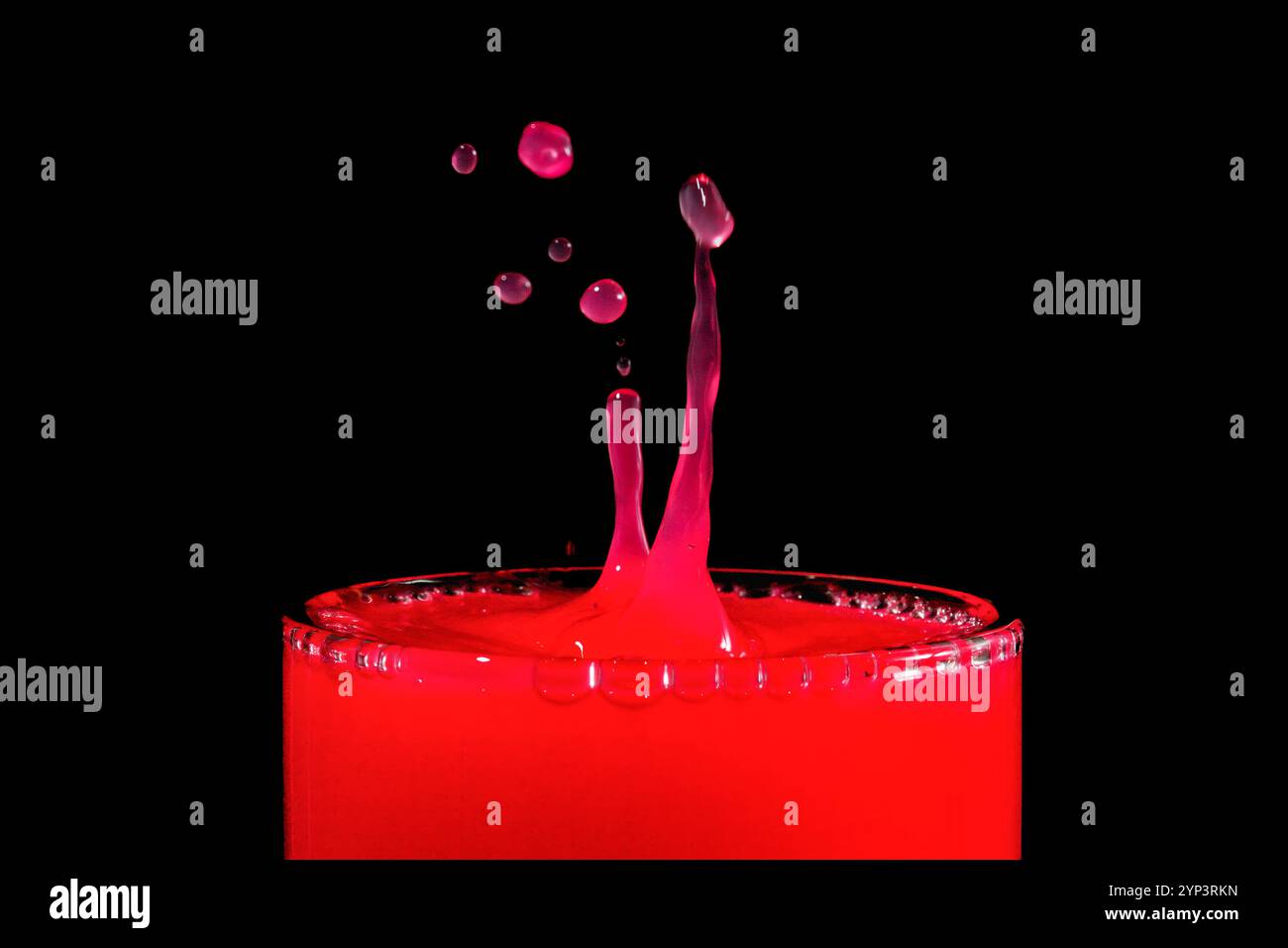 A vibrant splash of red liquid creates a visually stunning abstract ...
