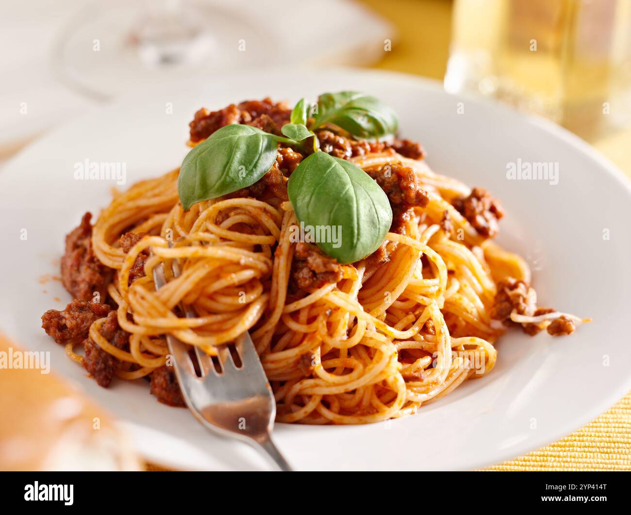 spaghetti with basil garnish in meat sauce Stock Photo - Alamy
