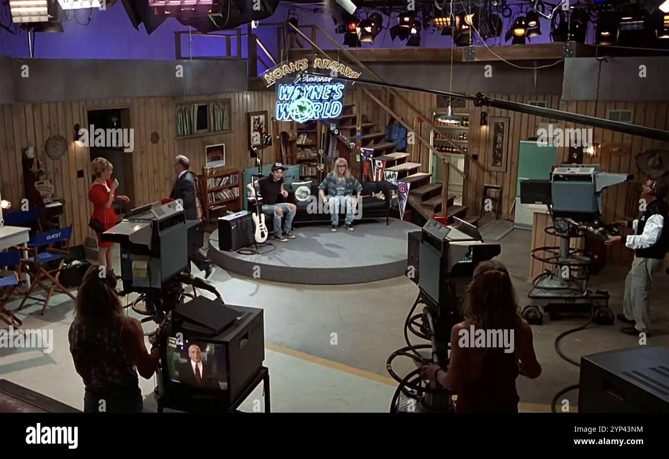 WAYNE'S WORLD 1992 Paramount Pictures film with Mike Myers as Wayne Campbell seated right and ...