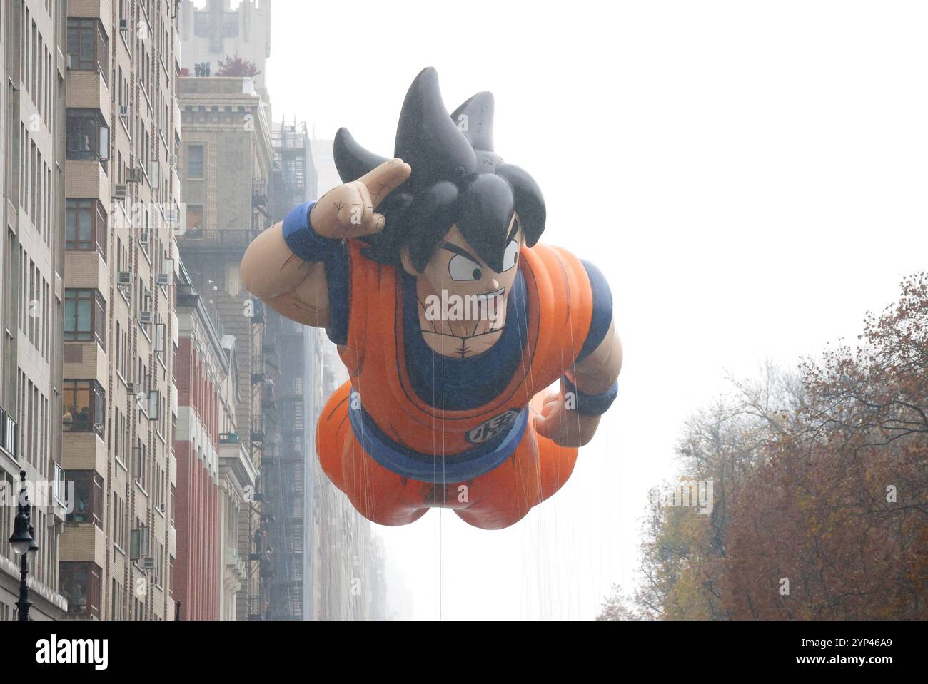 The Goku balloon floats past Columbus Circle in the rain during the 98th Macy's Thanksgiving Day ...