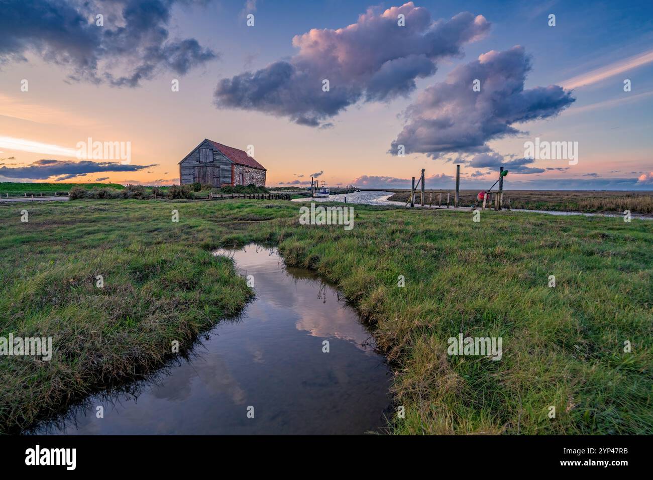 The old Coal Barn and Quay at Thornham Old Harbour, during sunset ...