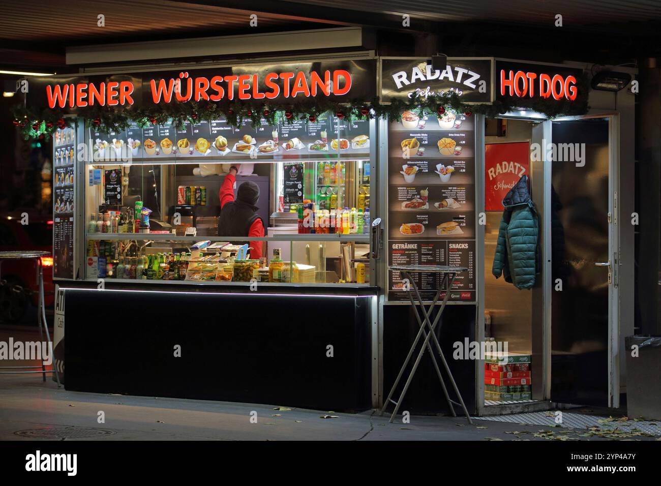 Customers line up at a traditional sausage stand (Wuerstelstand), which ...