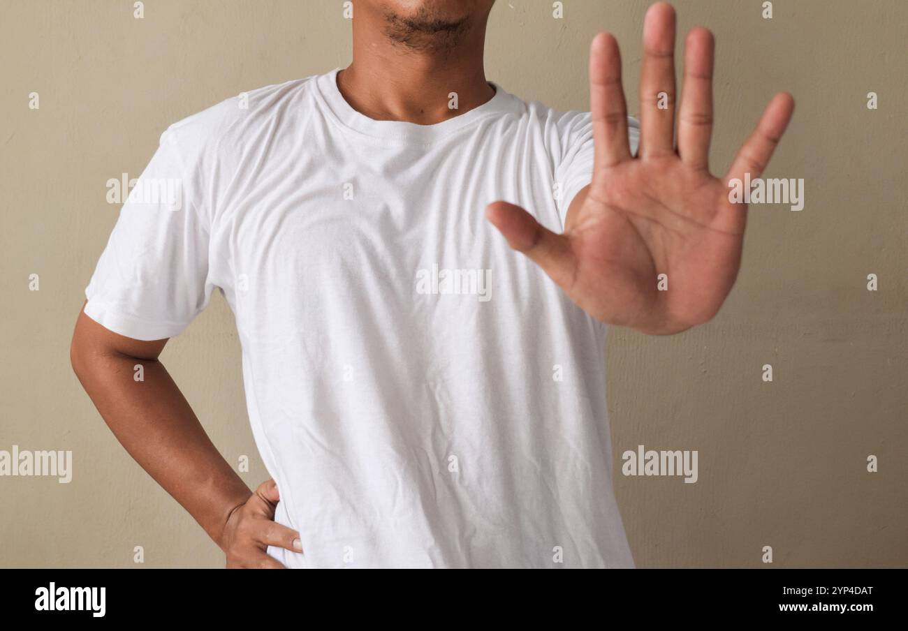 Man showing a refuse hand gesture sign Stock Photo - Alamy
