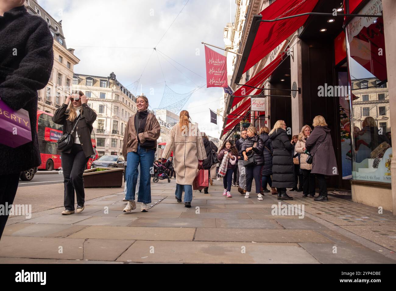 LONDON- NOVEMBER 25, 2024: Regent Street, busy London street scene. Landmark London retail ...