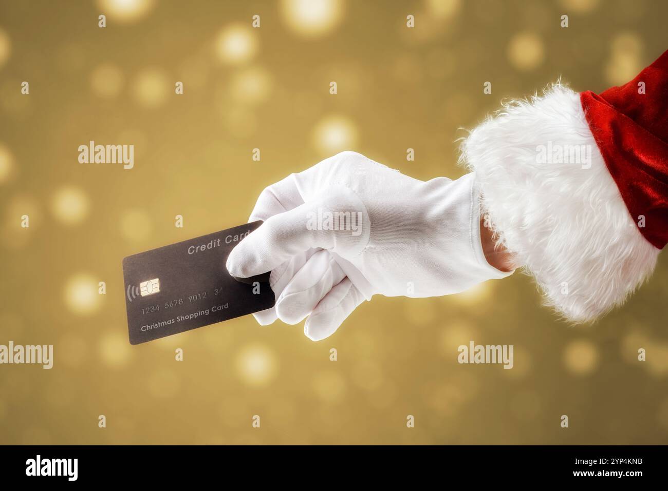 Santa Claus hand holding a credit card for Christmas shopping with ...