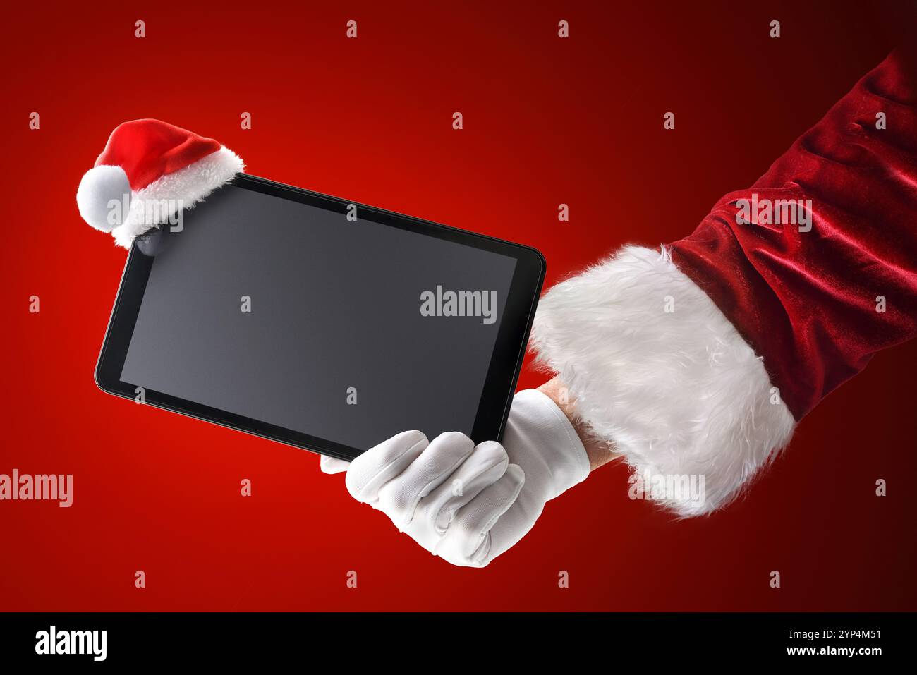 Hand of Santa Claus in suit and gloves holding a tablet with a Santa ...