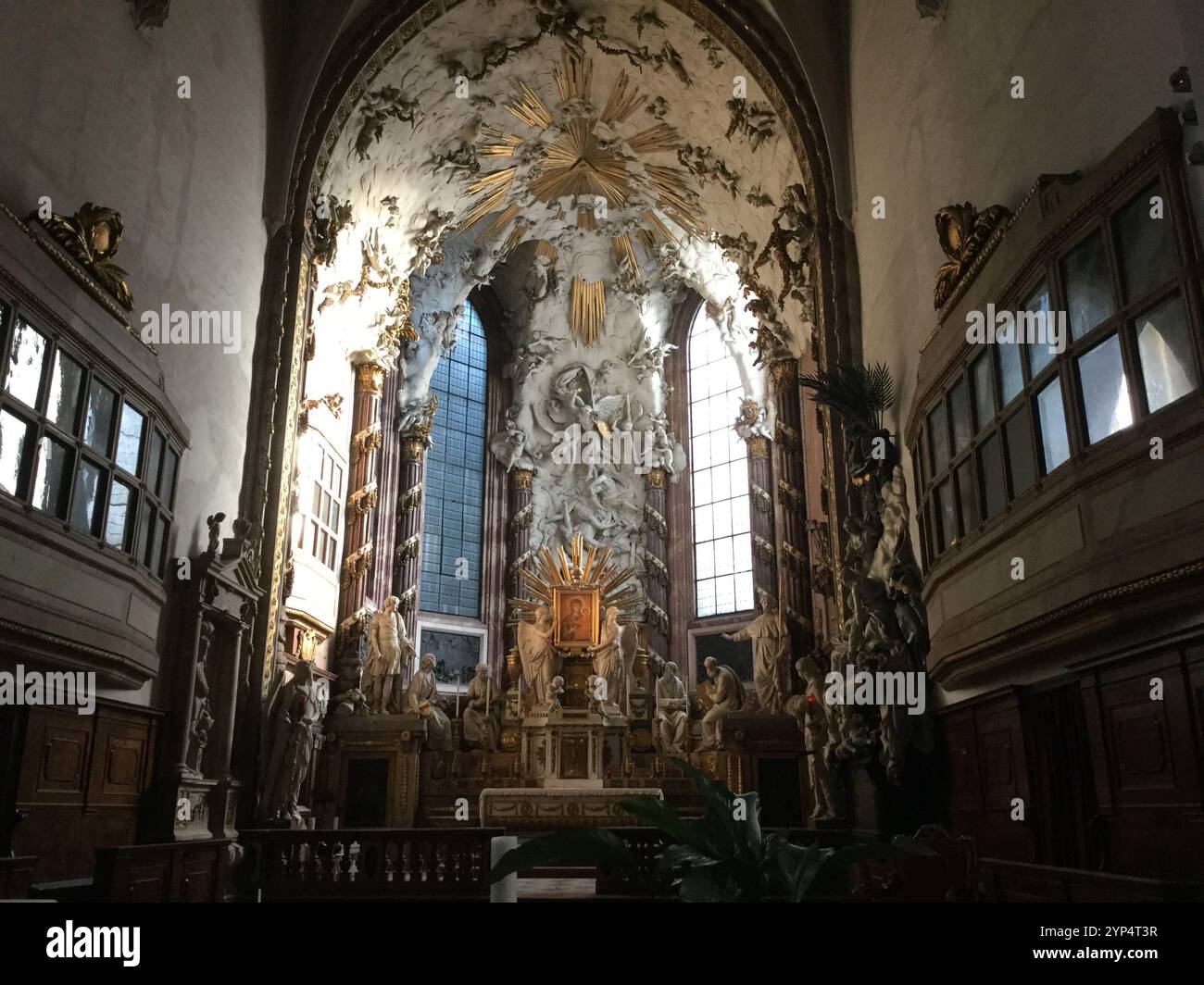 A stunning baroque altar features elaborate sculptures and gilded ...