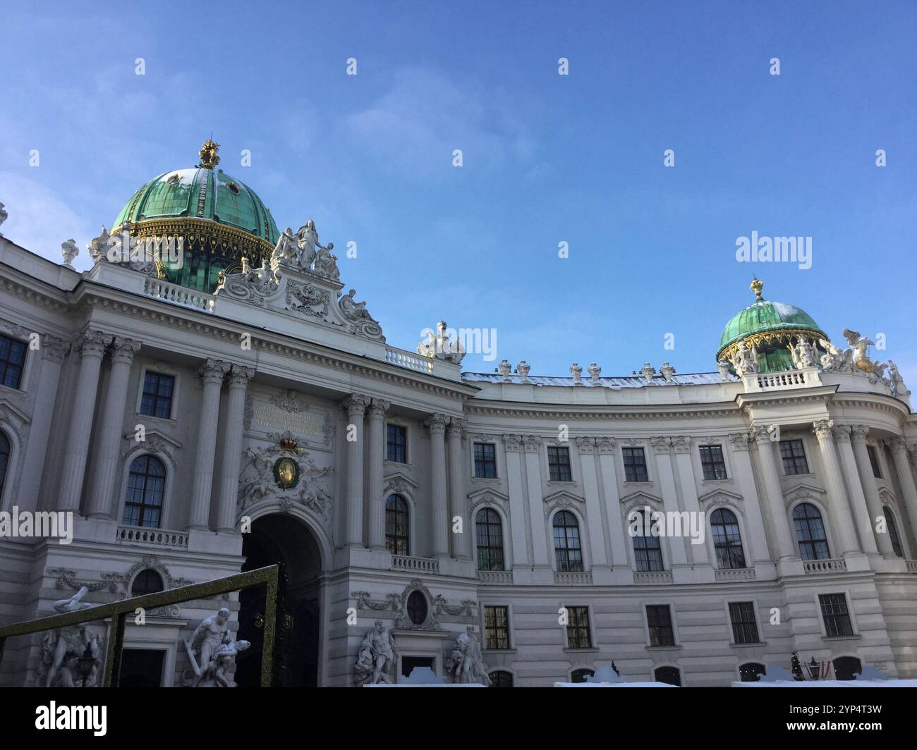 A grand palace showcases intricate architecture with green domes ...