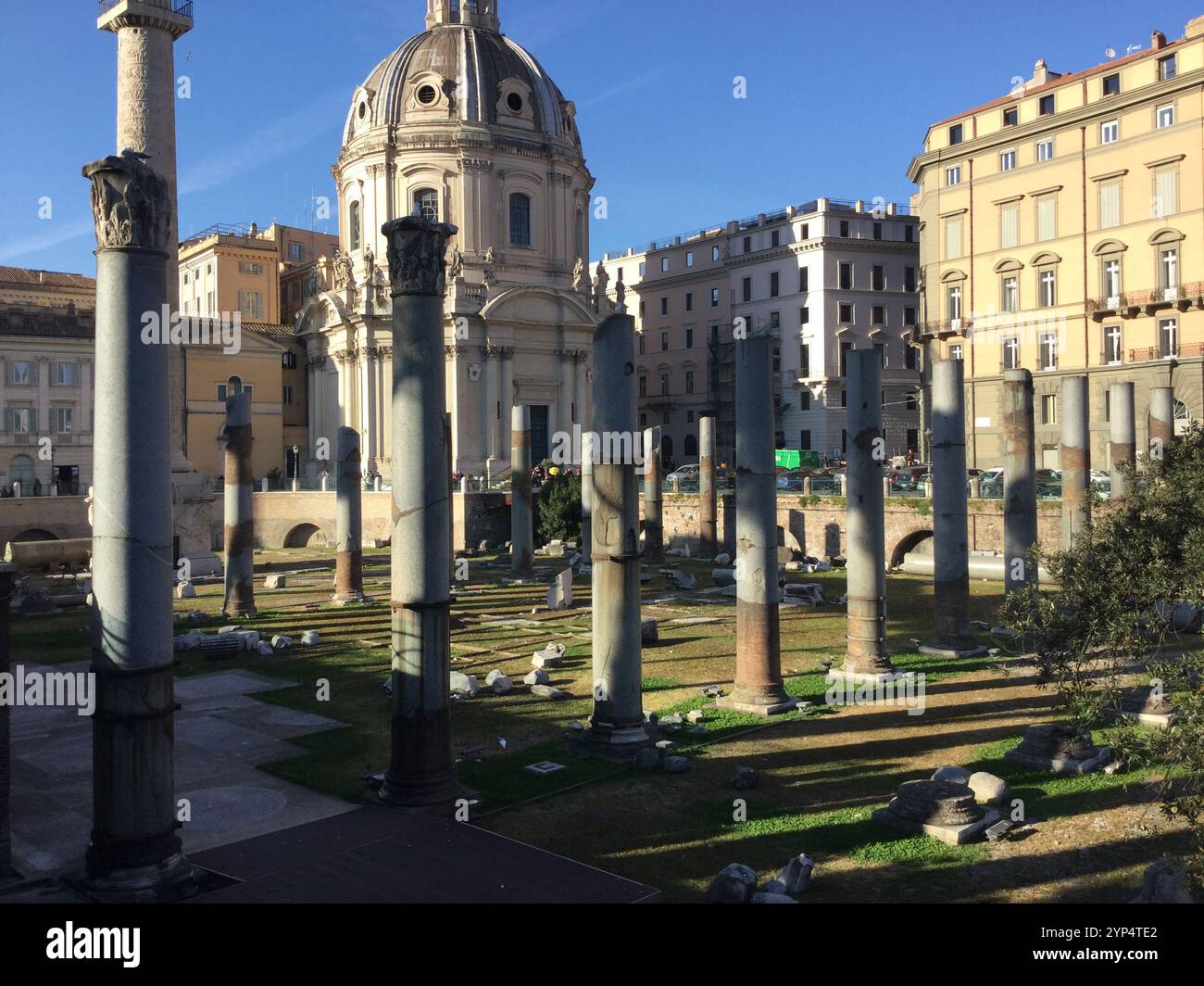 Ancient columns and remnants stand proud under a clear sky in a ...
