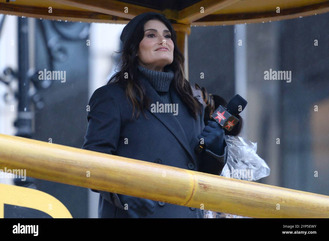 Actress and singer Idina Menzel stands on a float as she rides down ...