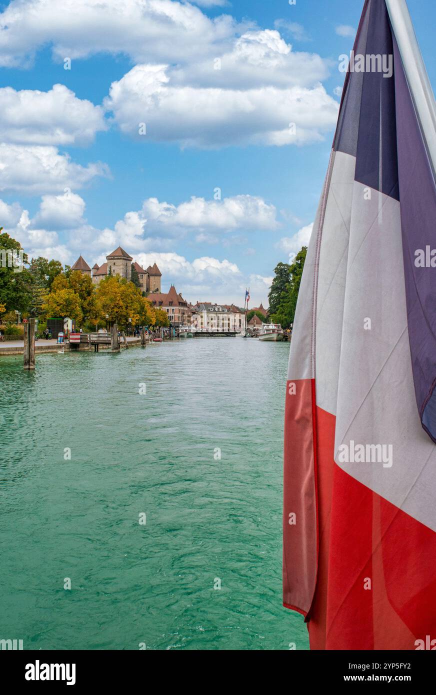 French flag flying off the back of a pleasure boat as it leaves Annecy ...