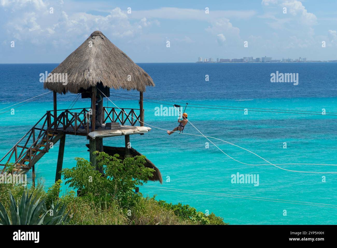 Vacation day on a tropical island in mexico with people on the zipline ...