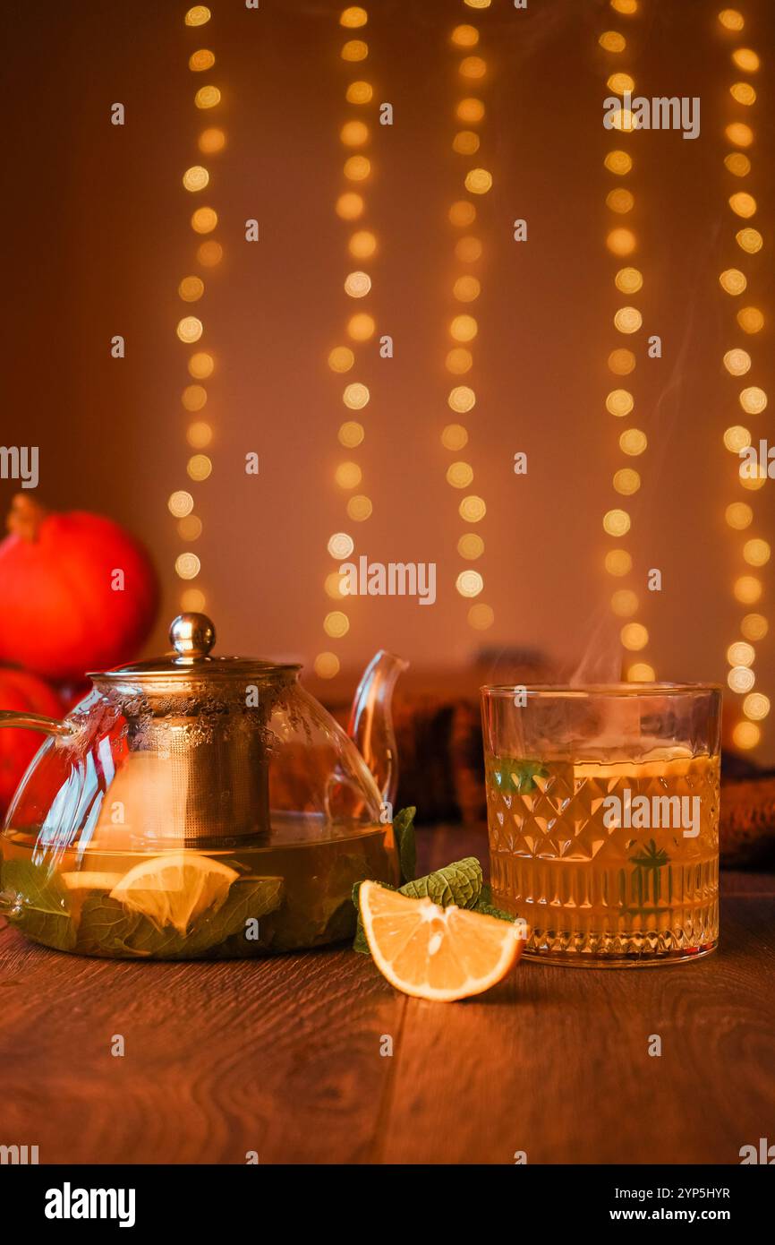 The process of brewing black tea with herbs, glass teapot with black ...