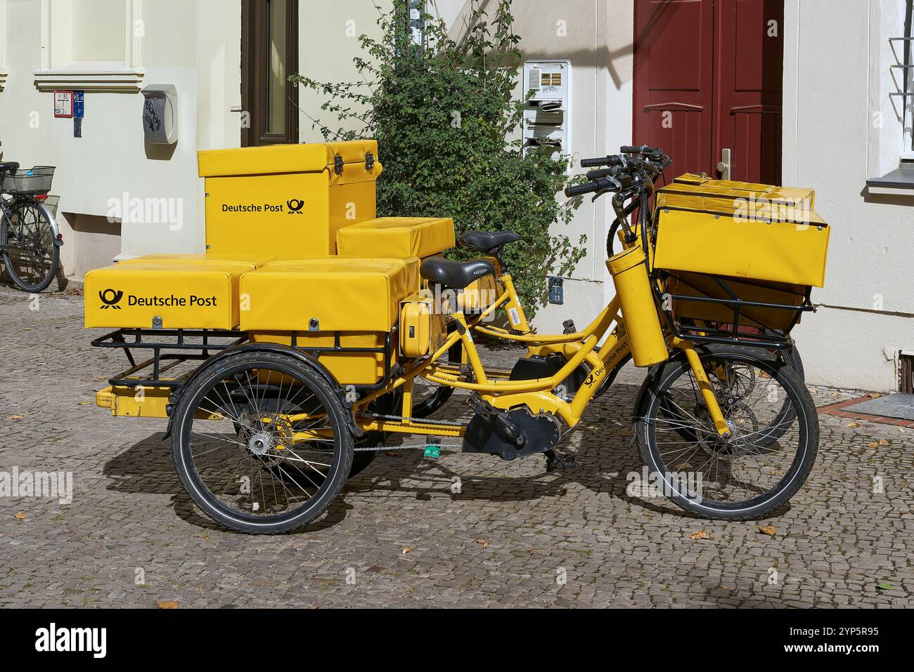 Bicycle of a letter carrier of Deutsche Post AG, part of the DHL Group in the city center of ...