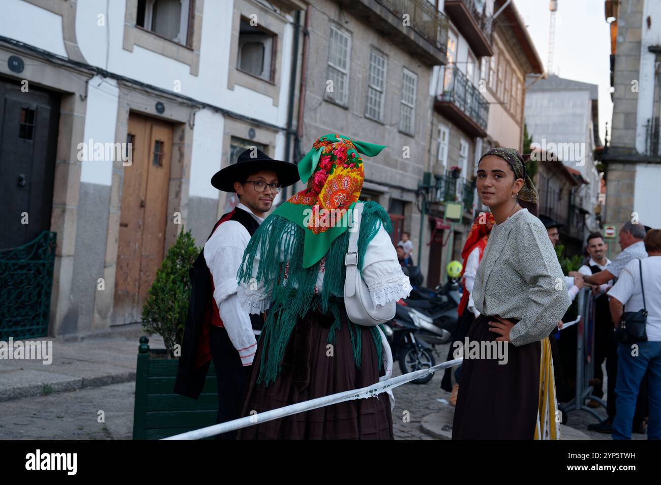 Portuguese people in vibrant traditional attire sharing moments at the ...