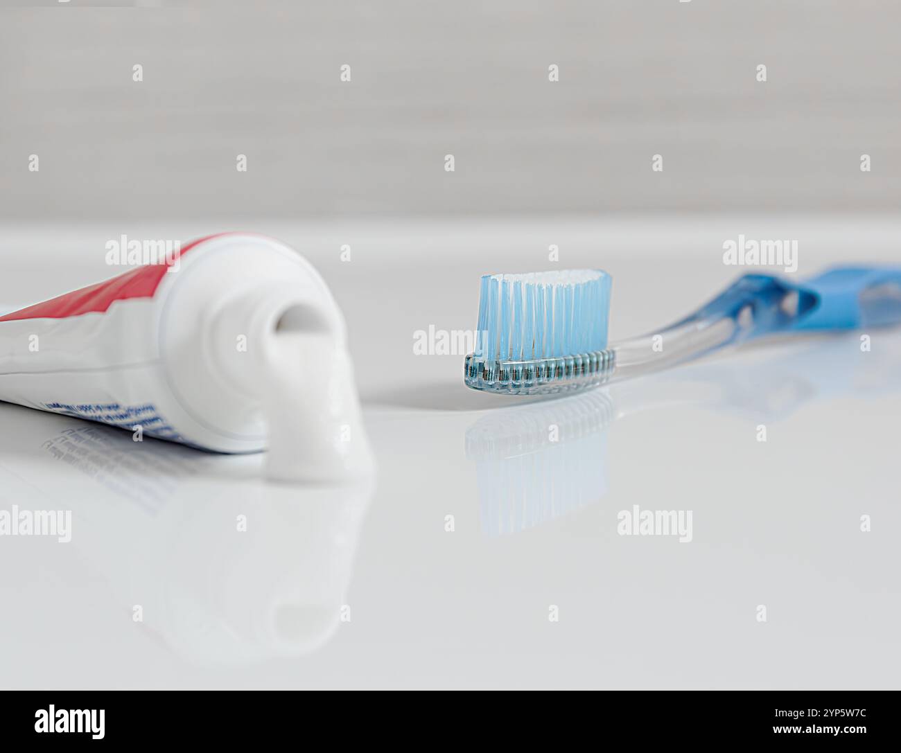 Toothbrush and paste on white countertup with blur background Stock ...