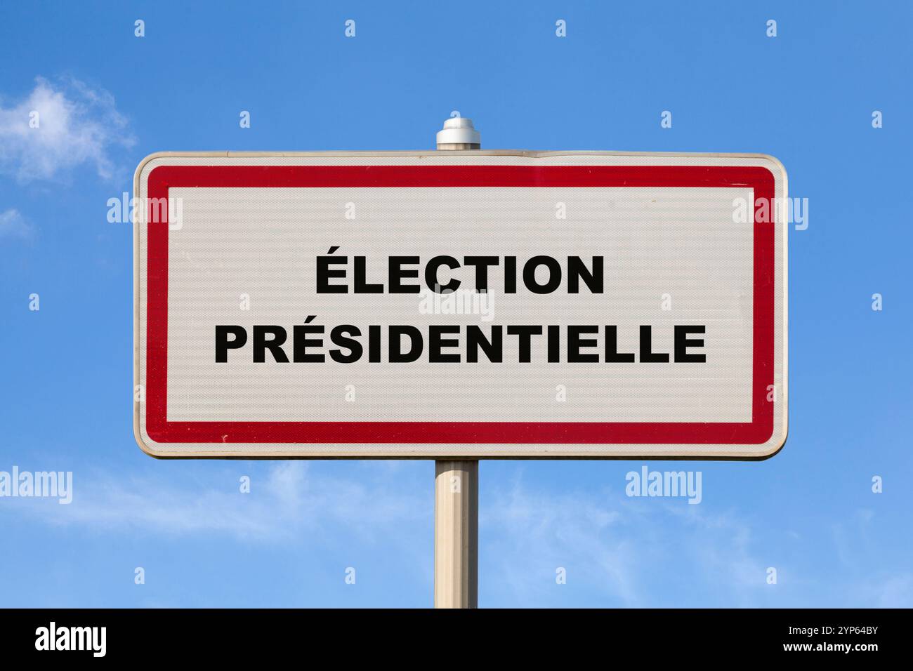 A French entry city sign against a blue sky with written in the middle ...