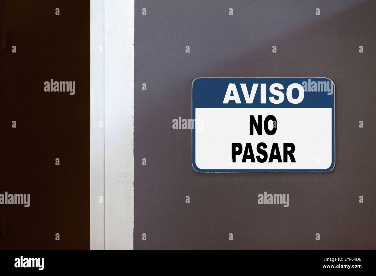 Blue and white notice sign on the side of an open door stating in ...