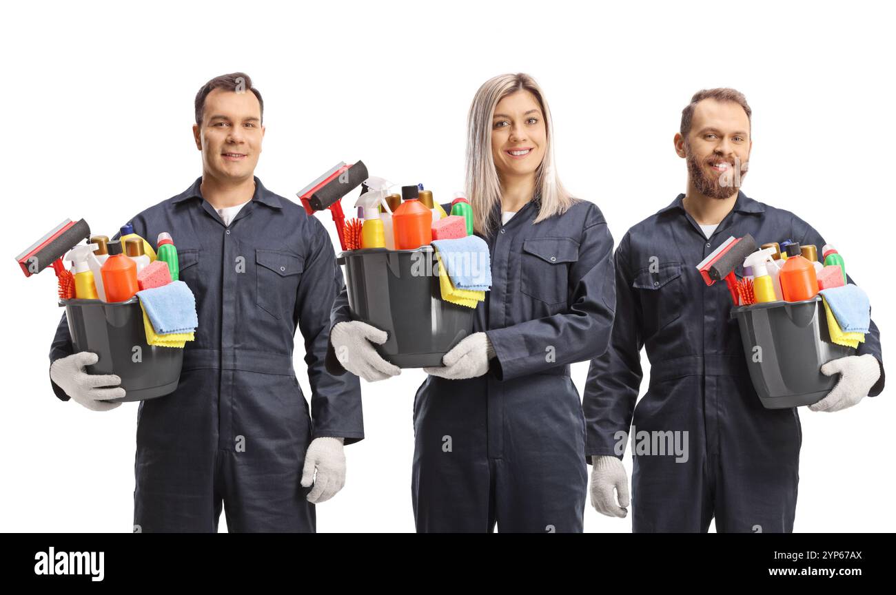 Team of cleaners in uniforms holding buckets with cleaning supplies ...