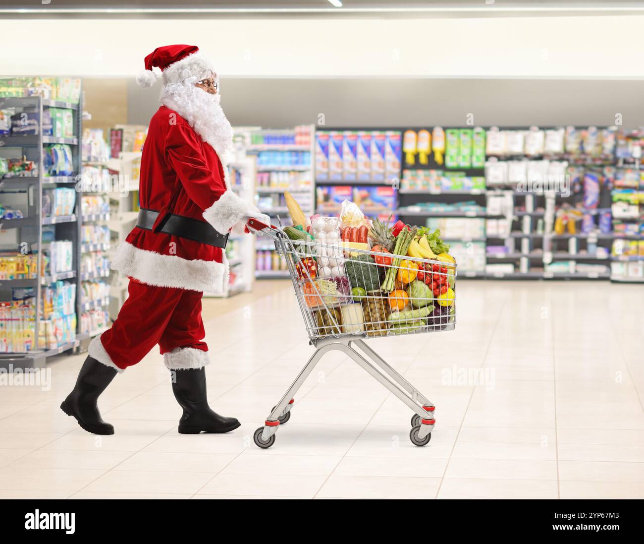 Santa Claus walking and pushing a shopping cart with food at a ...