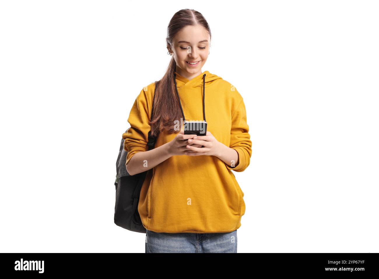 Female teenager typing on a smartphone and smiling isolated on white ...
