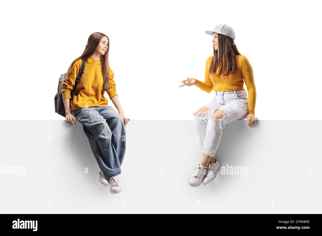 Sisters sitting on a panel and talking isolated on white background ...