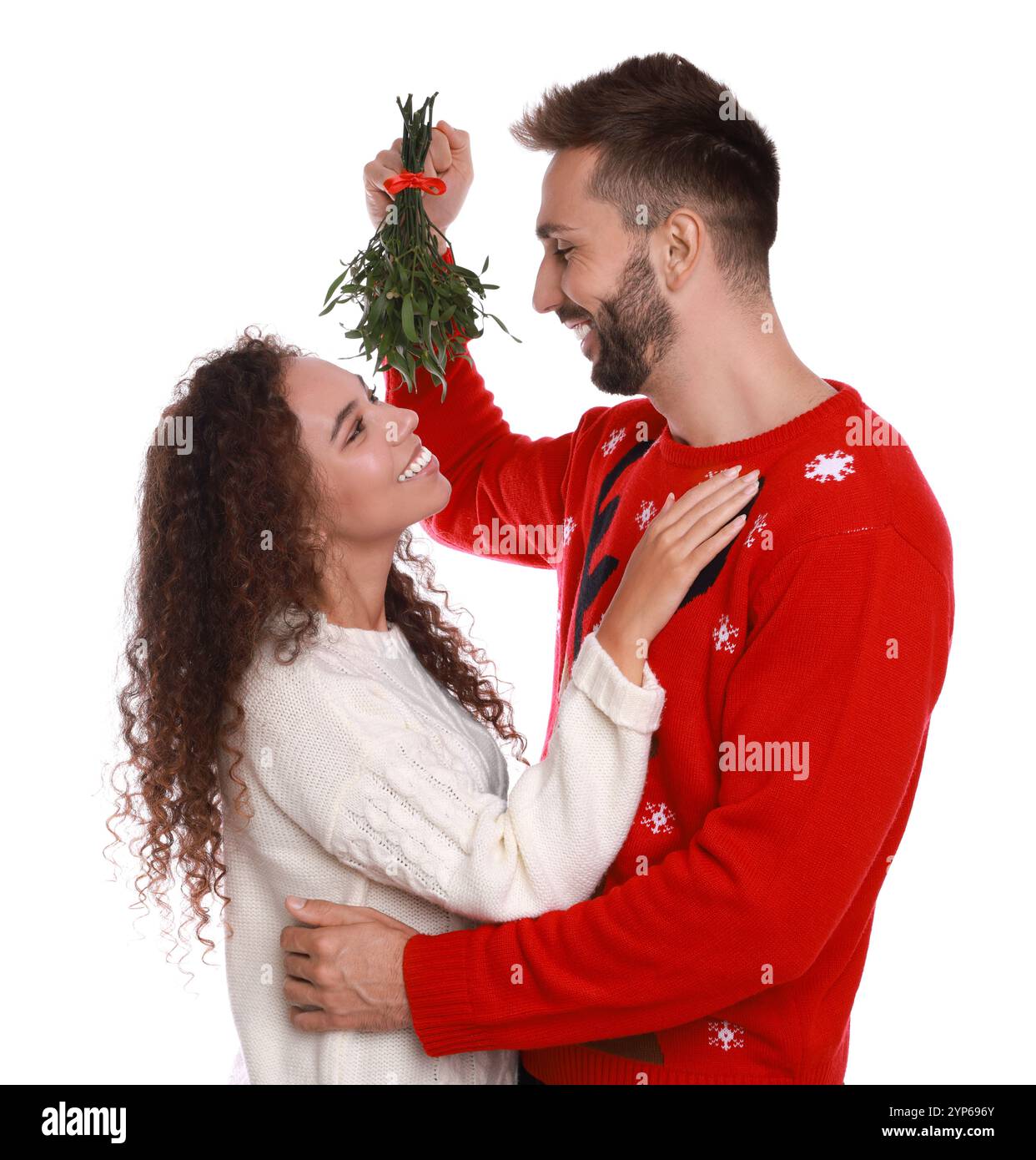 Lovely couple under mistletoe bunch on white background Stock Photo - Alamy