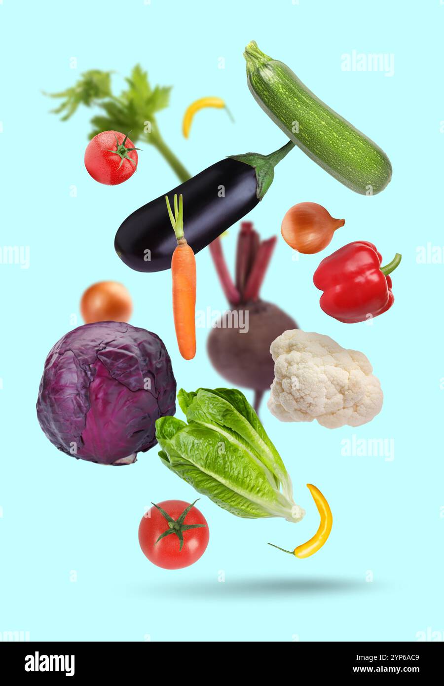Different fresh vegetables in air on light blue background Stock Photo ...