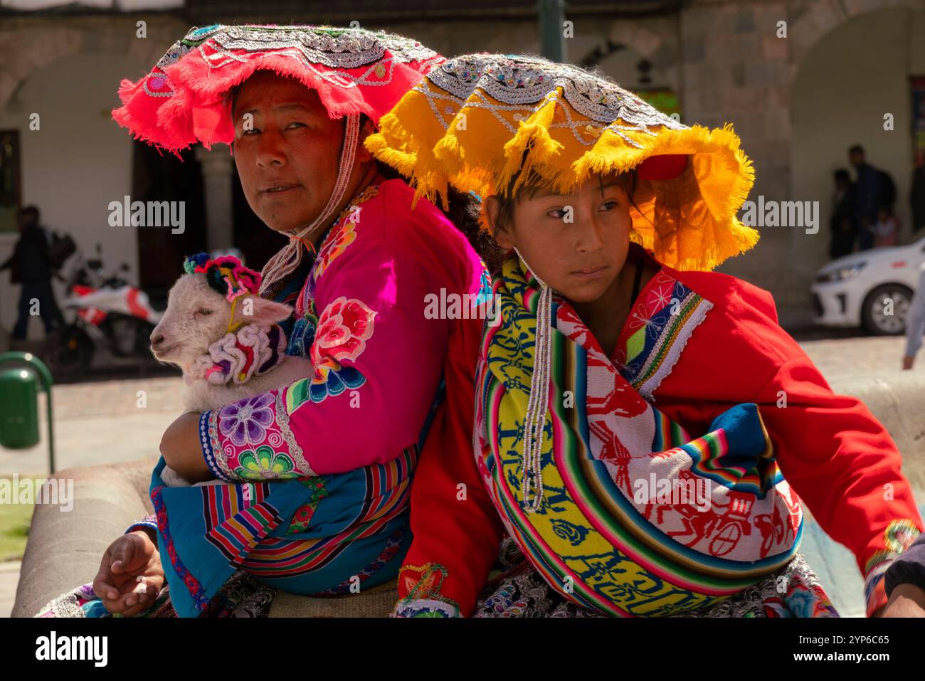 a mom and a daughter dressed in colors and typical Clothing of Peru ...