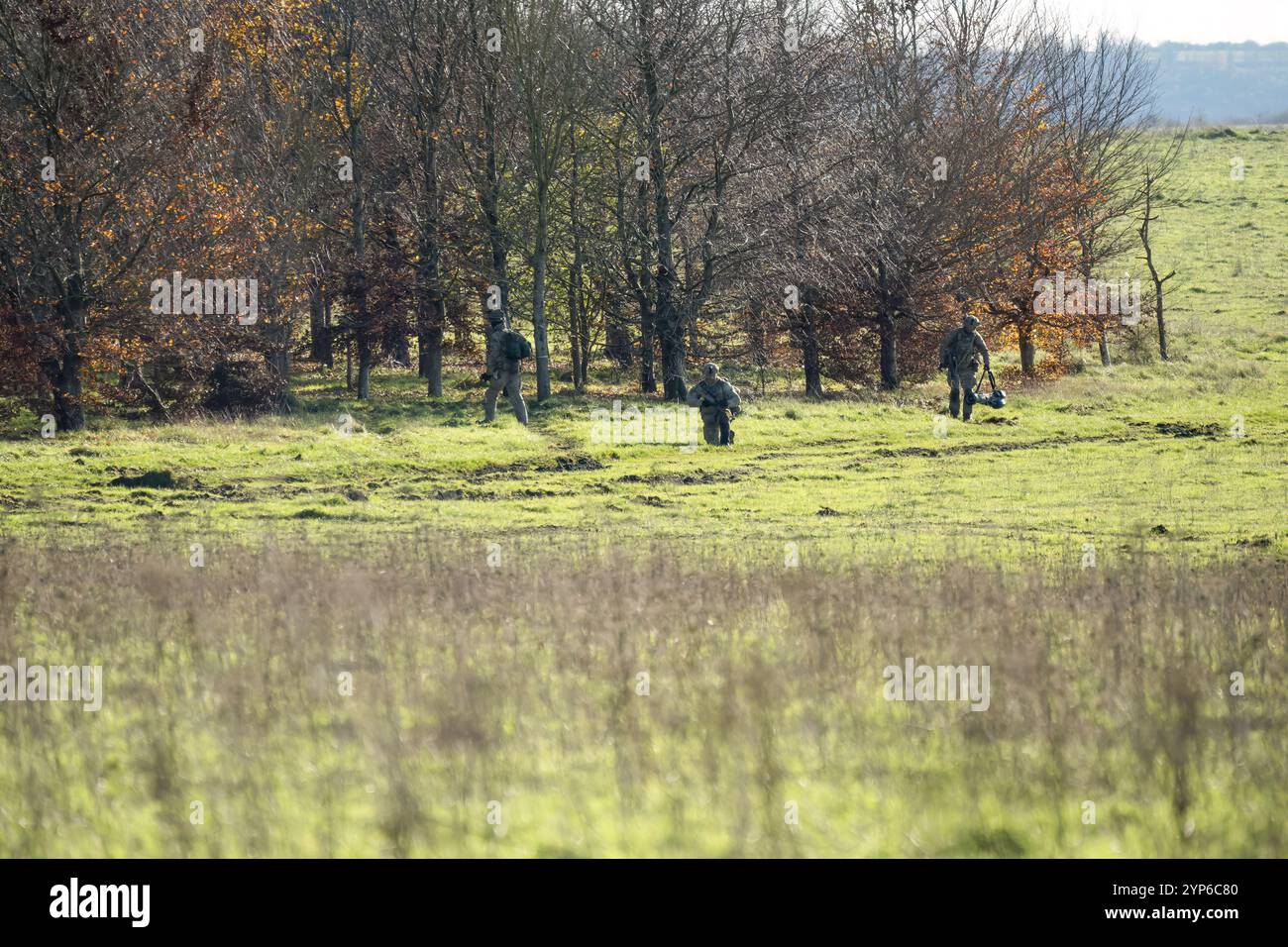 three soldiers on exercise moving in to woodland with an NLAW (MBT-LAW ...